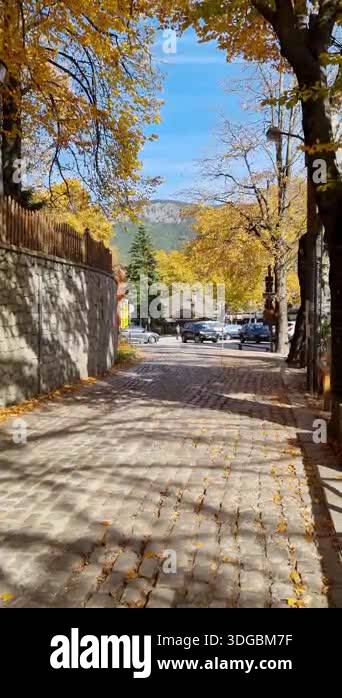 Walking down a traditional cobblestone street in Metsovo village Greece ...