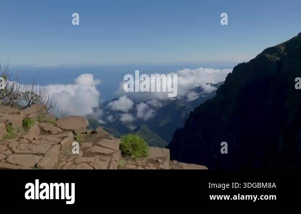 female hiker walking cliffside mountain trail with binoculars and ...