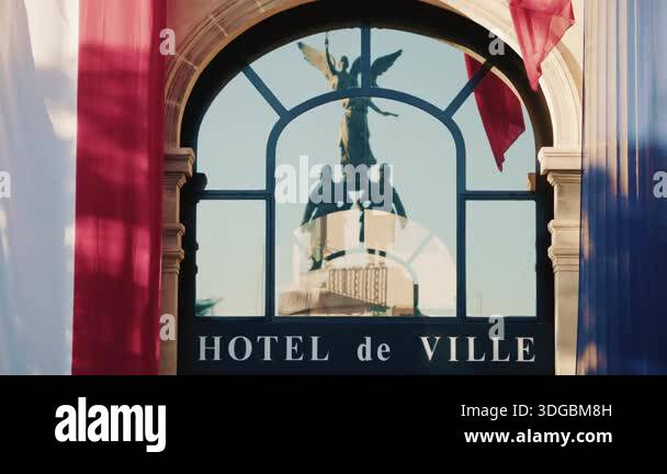 French city hall entrance with tricolor flags and reflection of a ...
