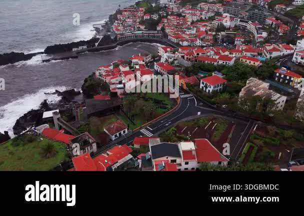 colorful cliffside village with red roofs and winding roads, aerial ...