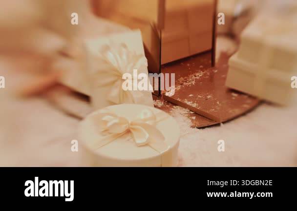 Golden Christmas baubles hanging from a structure alongside a suspended ...