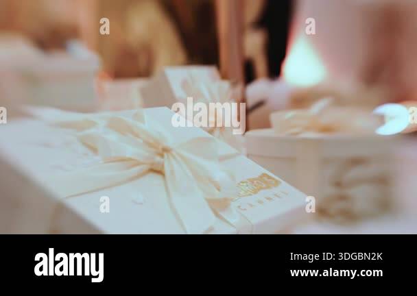 Golden Christmas baubles hanging from a structure alongside a suspended ...