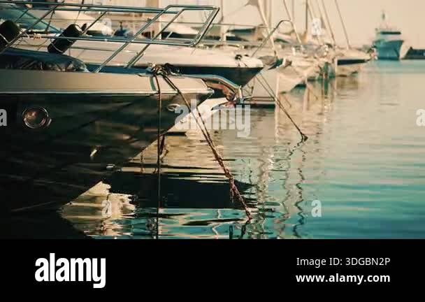 Close up of the bow of a luxury yacht with mooring ropes and metal ...