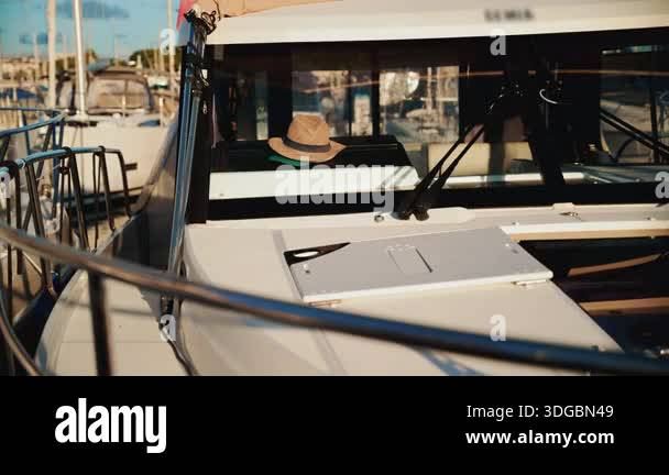 Close up of a straw hat placed inside the cockpit of a moored motorboat ...