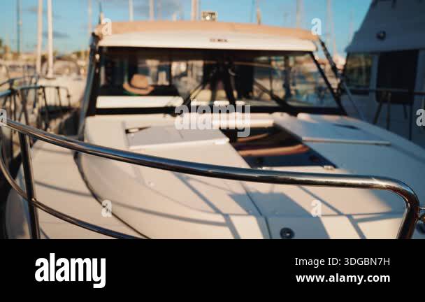 Close up of a straw hat placed inside the cockpit of a moored motorboat ...