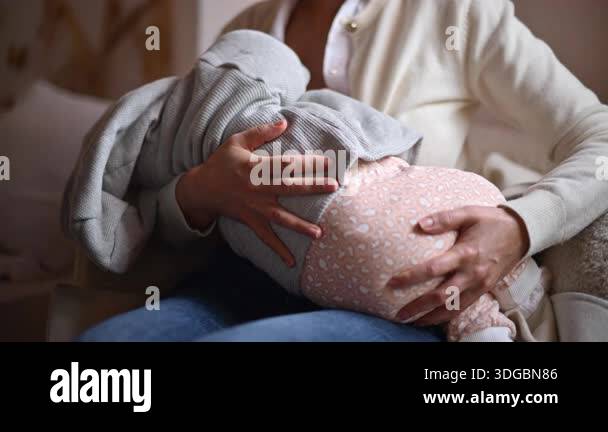 Smiling mom gently holding a baby inside a cafe Stock Video Footage - Alamy