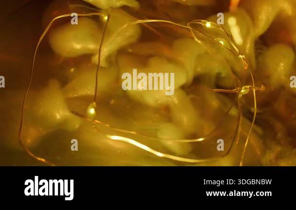 Ink wave. Light texture. Defocused golden yellow orange color glitter ...