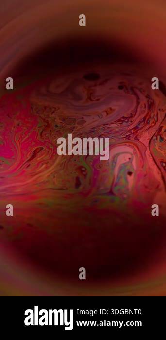 Vertical video. Defocused paint swirl. Liquid planet sphere. Red orange ...