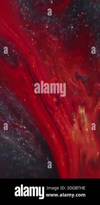 Vertical video. Drip art. Spill texture. Defocused red silver color ink ...