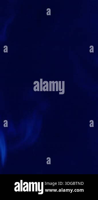 Vertical video. Haze flow. Color fume. Defocused blue neon ink in water ...