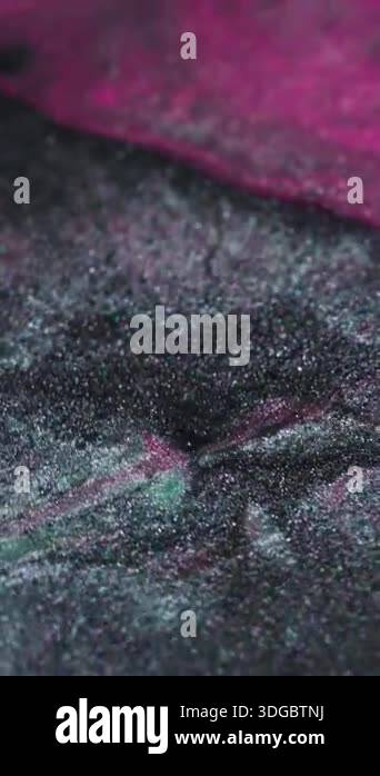 Vertical video. Shimmering splash. Glitter paint spill. Defocused pink ...