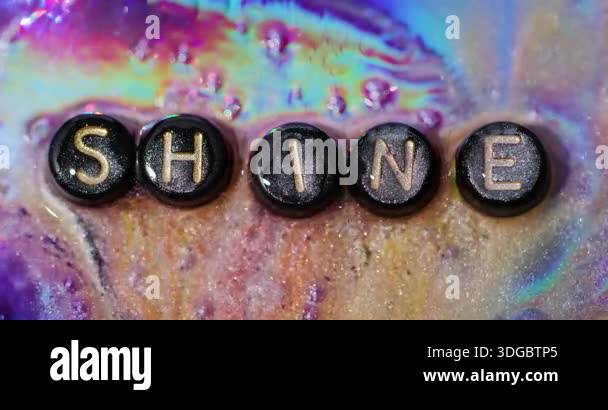 Shine letter. Shimmer paint. Defocused yellow blue orange color flow ...