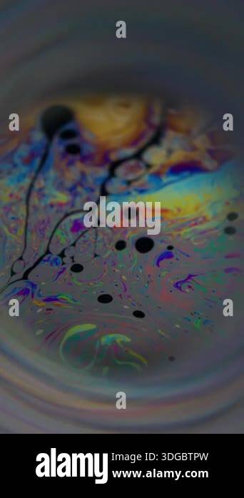 Vertical video. Ink blur mix. Rainbow oil. Multicolor round lens wave ...