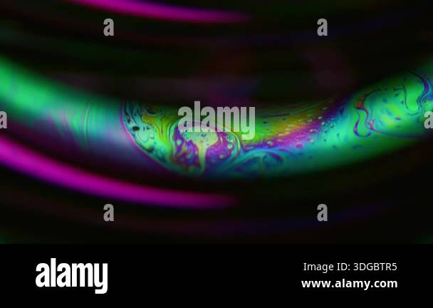 Defocused paint droplet. Ink liquid. Green yellow purple color oil ...