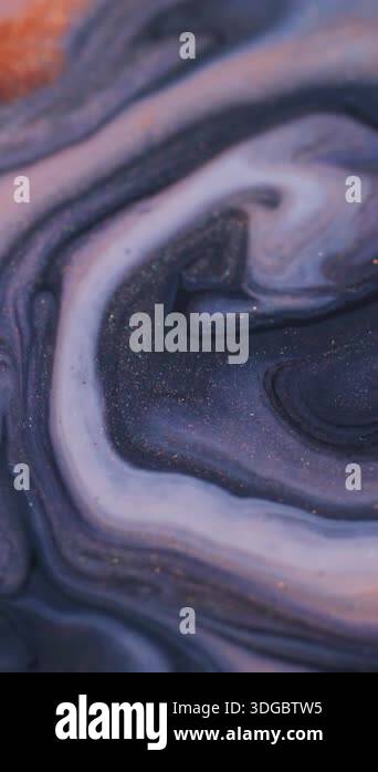 Vertical video. Marble whirl. Glitter ink mix. Defocused blue pink ...
