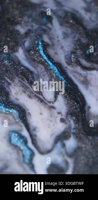 Vertical video. Marble ink texture. Glitter fluid spill. Defocused blue ...