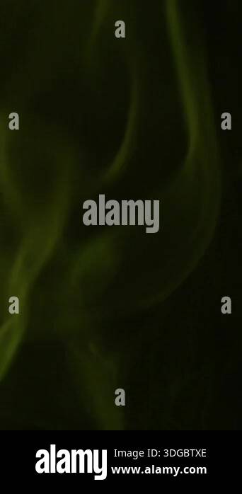 Vertical video. Mist fume. Water ink. Defocused green neon color smoke ...