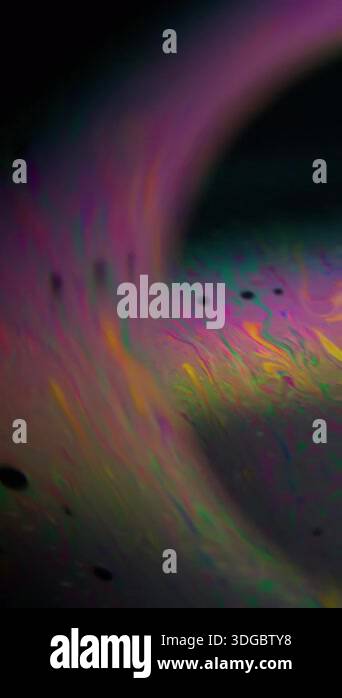 Vertical video. Defocused paint planet. Spectrum ink fluid. Oil soap ...