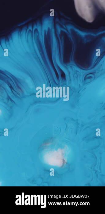 Vertical video. Spreading ink. Pigment texture. Defocused blue white ...