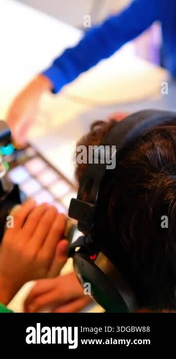 cute boys wearing headphones, adjusting music mixer Stock Video Footage ...