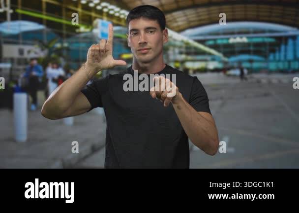 Man making loser sign gesture with left hand framing an l shape and ...