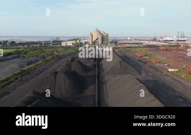 Aerial drone view of huge coal and iron ore storage depot, piles of ...