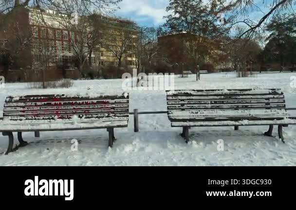 Wide shot of Orange Garbage Bin and Bench on a winter Day in Gorlitzer ...