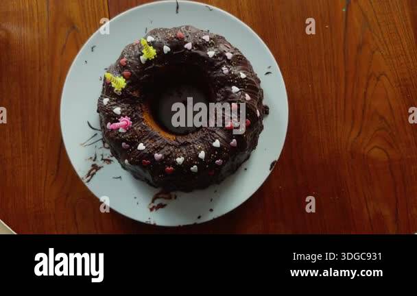 Close-up details of a mother lightning candles on homemade chocolate ...