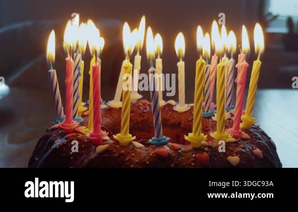 Close-up details of a mother lightning candles on homemade chocolate ...