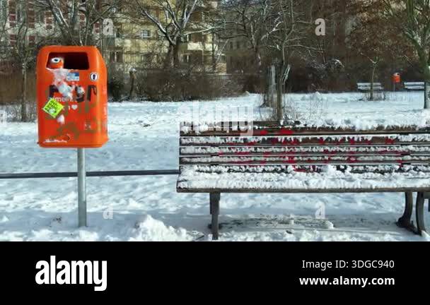 Wide shot of Orange Garbage Bin and Bench on a winter Day in Gorlitzer ...