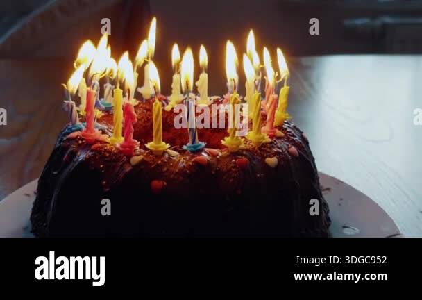 Close-up details of a mother lightning candles on homemade chocolate ...