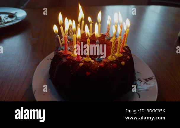 Close-up details of a mother lightning candles on homemade chocolate ...