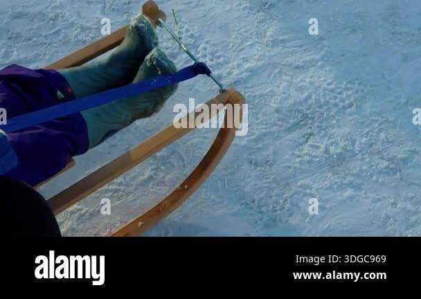 Mother and child on sled, enjoying the snow on a cold seasonal day in ...