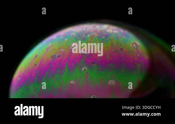 A mesmerizing seamless 4K macro loop of a giant soap bubble floating ...