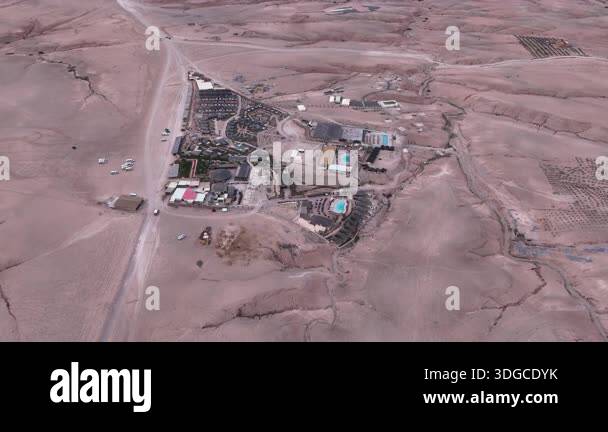 aerial view of desert resort compound with turquoise pools, buildings ...