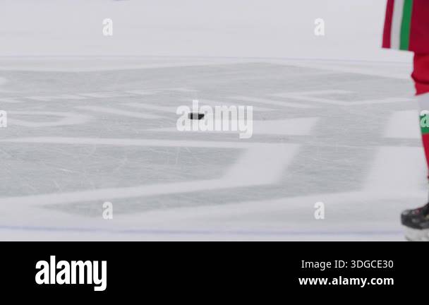 Hockey players fight for puck skating along ice rink slow motion ...