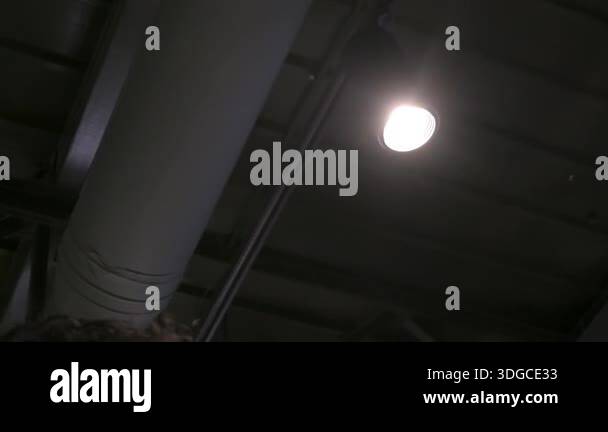 Technician hand in glove adjusts spotlight at shooting set closeup ...