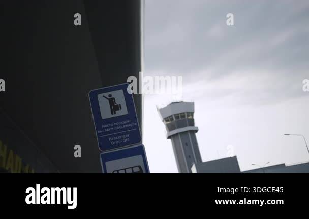 Passenger drop off place at airport terminal building under cloudy sky ...