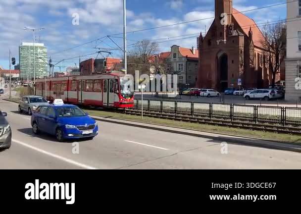 modern Gdansk tram on street track with overhead power lines and city ...