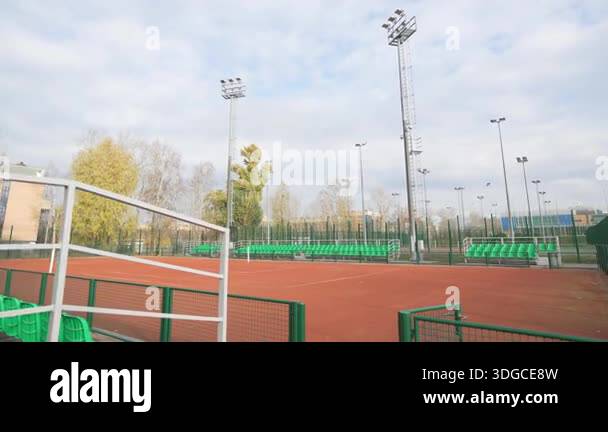 Spacious tennis court surrounded by spectator stands creates ideal ...
