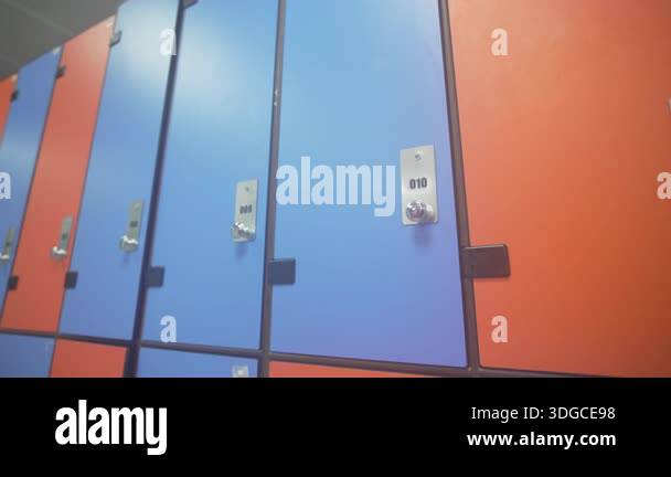 Order in locker room achieved through numbered locker doors. Bright ...