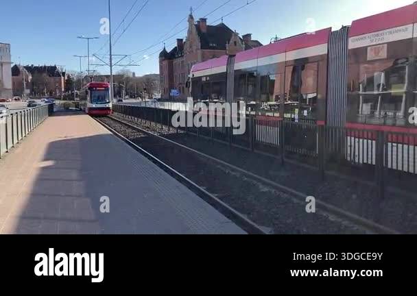 modern Gdansk tram on street track with overhead power lines and city ...