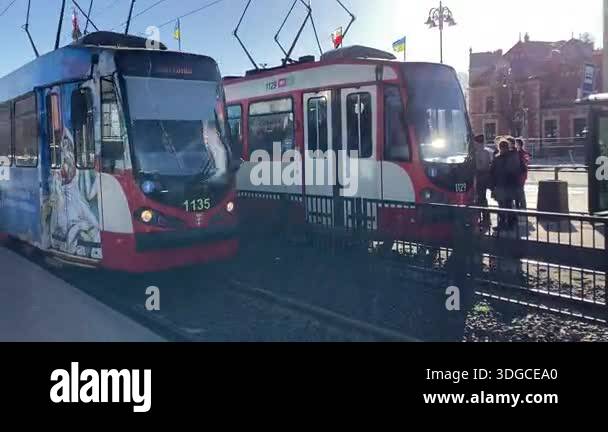 modern Gdansk tram on street track with overhead power lines and city ...