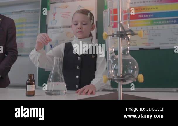 ALMATY, KAZAKHSTAN - DECEMBER 07 2025: Schoolgirl performs chemistry ...