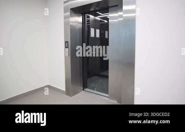 Shiny elevator door slowly closes ensuring complete passenger safety ...
