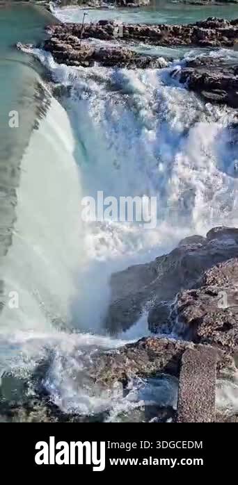 Close-up top view of a waterfall cascading over rocks. Flowing water ...