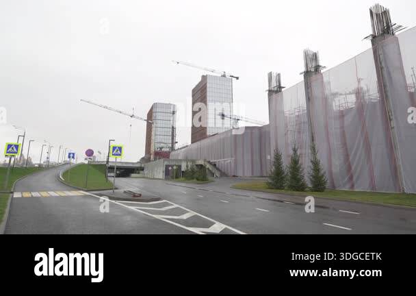 Construction site with concrete columns located beside busy highway ...