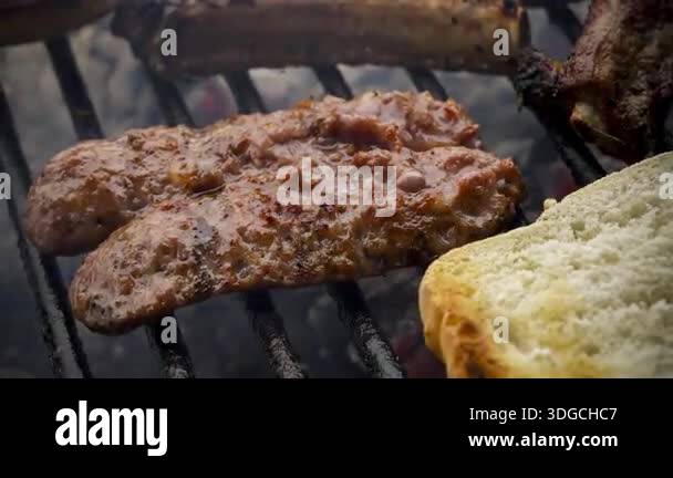 Juicy minced meat sausages, pork ribs, and slices of white bread ...