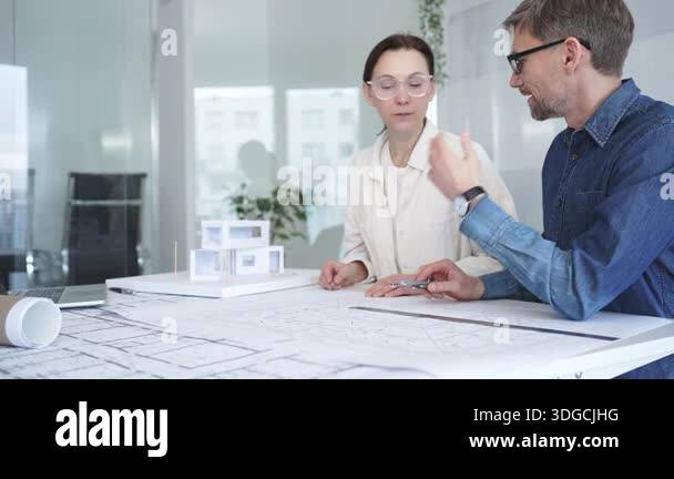 Architects developing a new building project, collaborating and ...