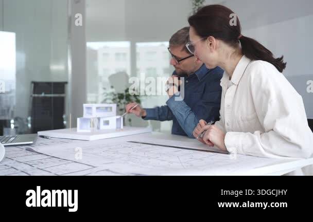 Architects developing a new building project, collaborating and ...